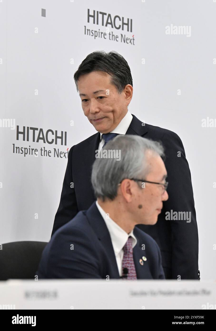 Hitachi, Ltd. Vice President Toshiaki Tokunaga (upper) attends a press ...