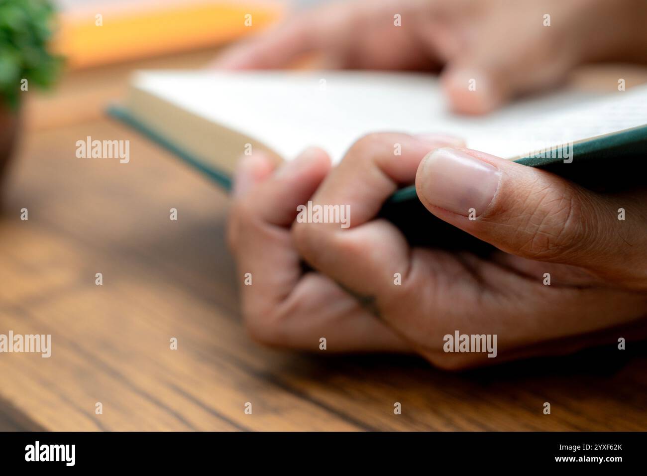 hands open and reading a book Stock Photo - Alamy