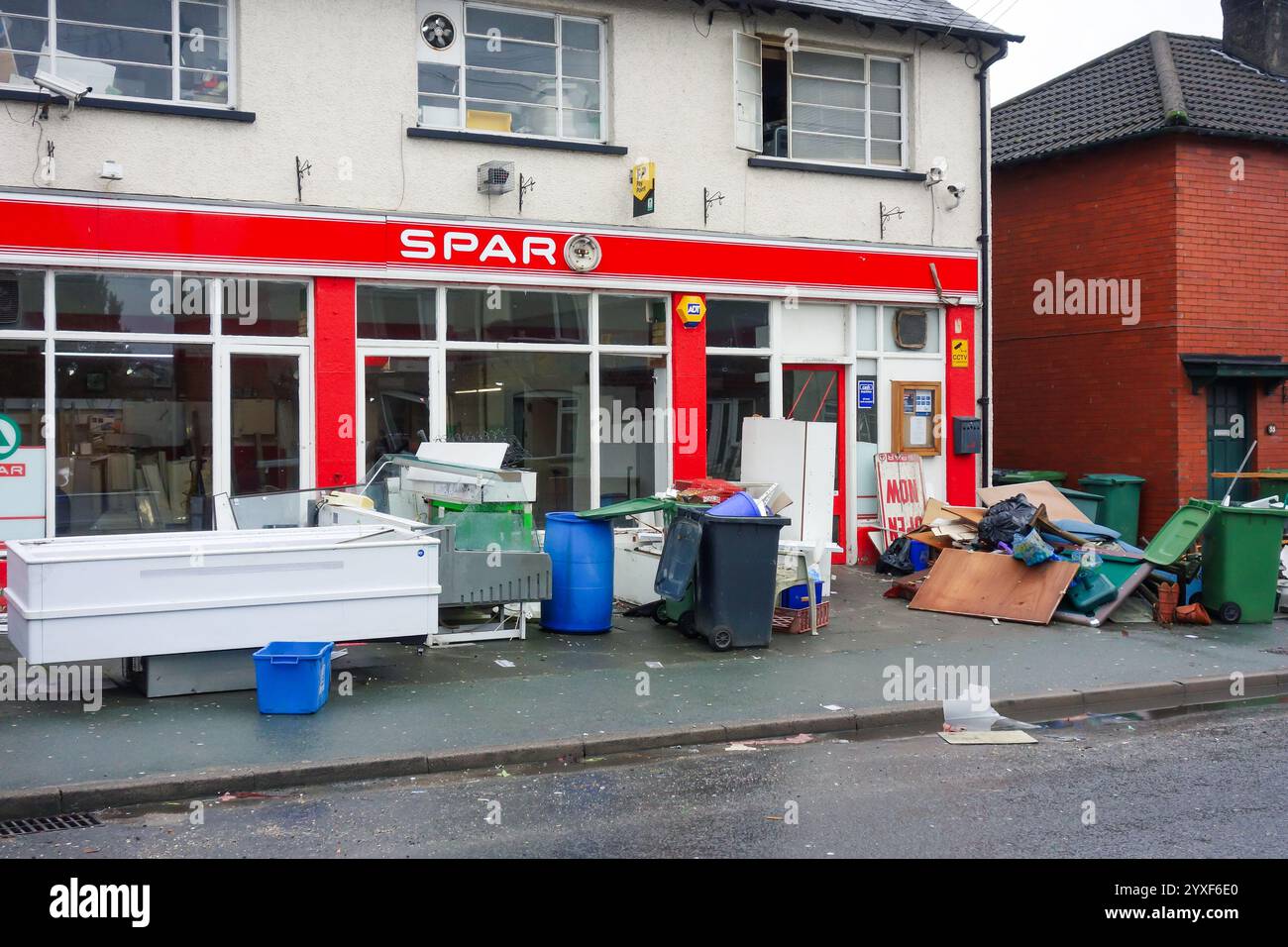 Flood damaged shop fittings and other items outside a Spar convenience ...
