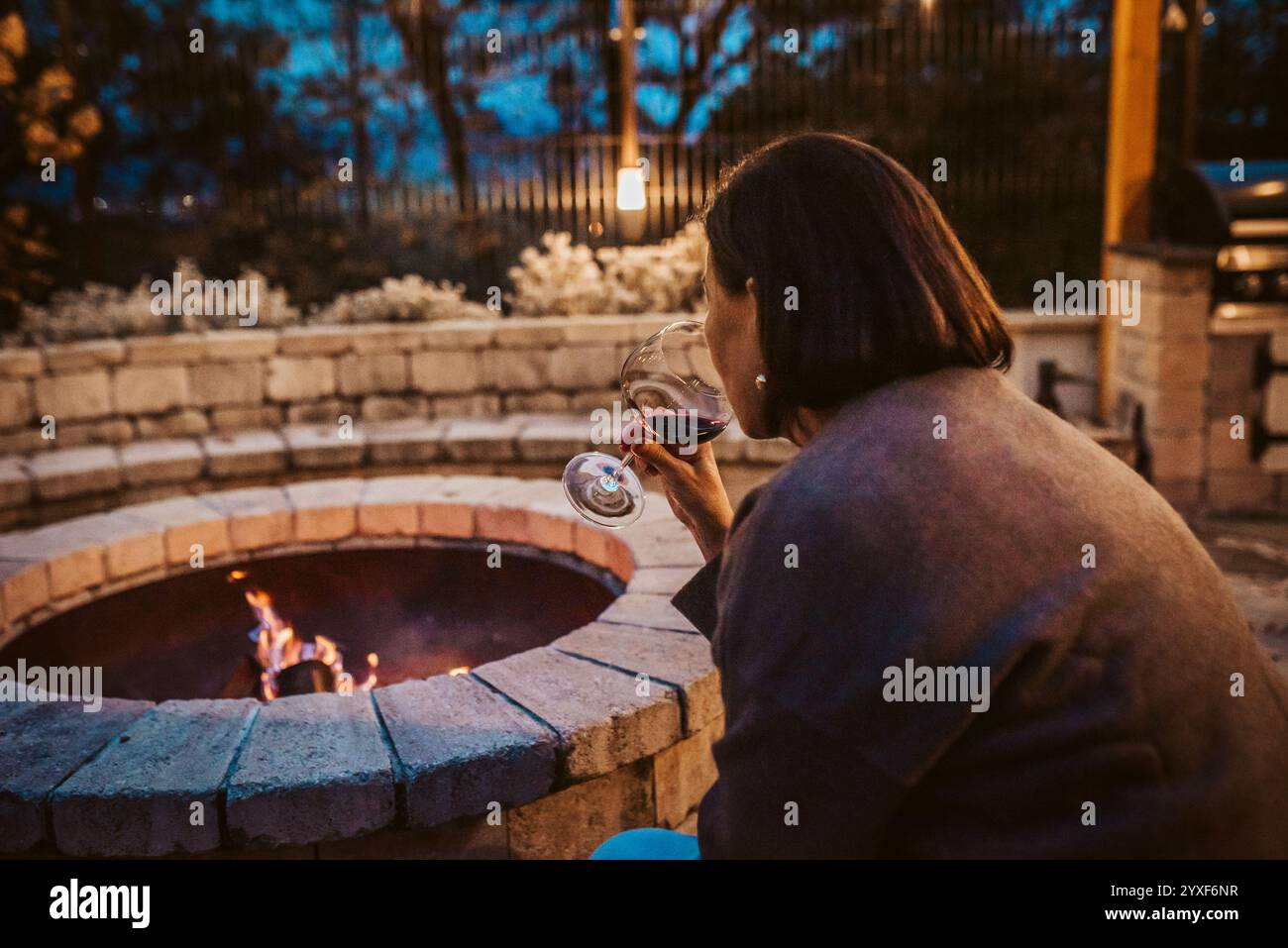 Elderly woman sitting by fire hi-res stock photography and images - Alamy