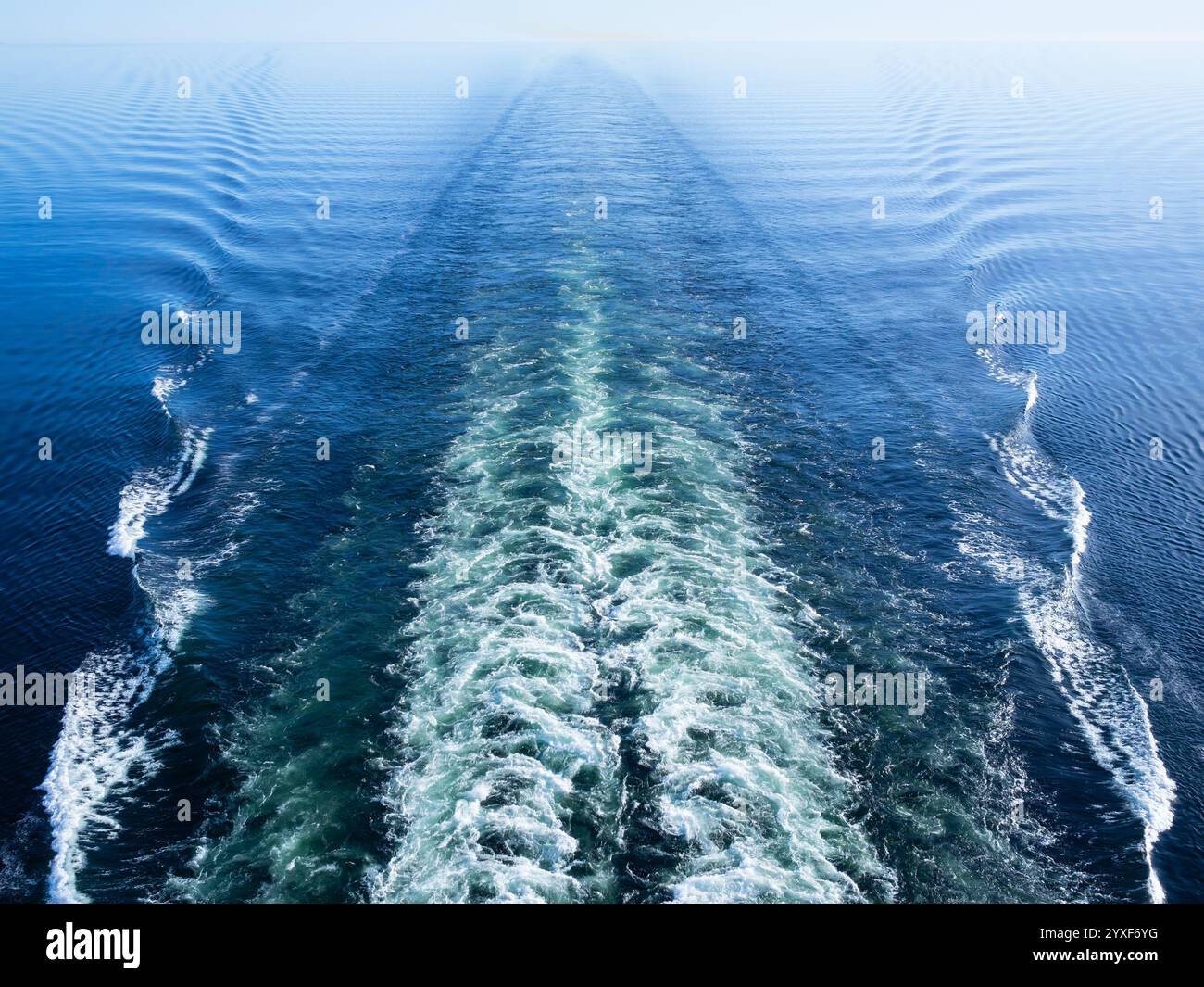 The turbulent wash from a large cruise ship flowing off to the horizon ...