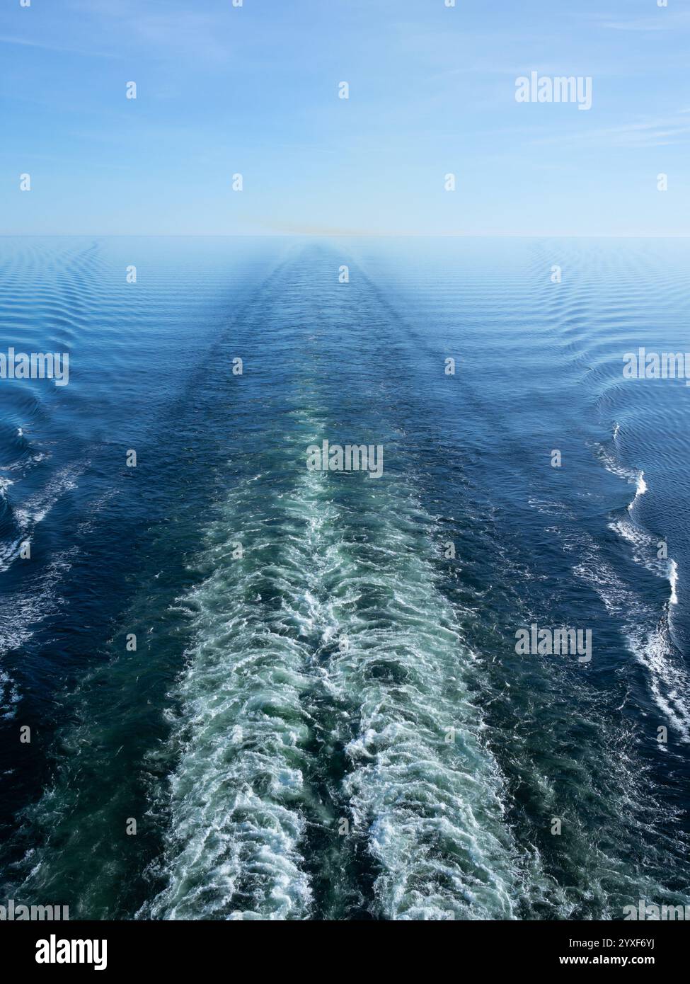 The turbulent wash from a large cruise ship flowing off to the horizon ...