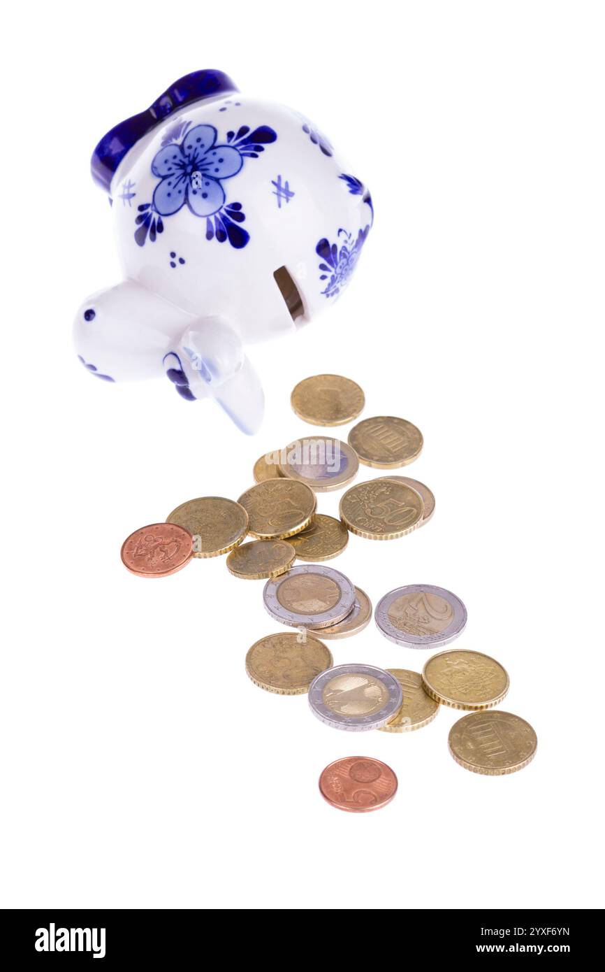 Piggy bank in a shape of a cow with blue ornament and scattered coins ...