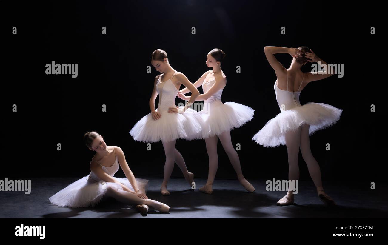 Four young graceful young ballet dancers, girls in beautiful white ...