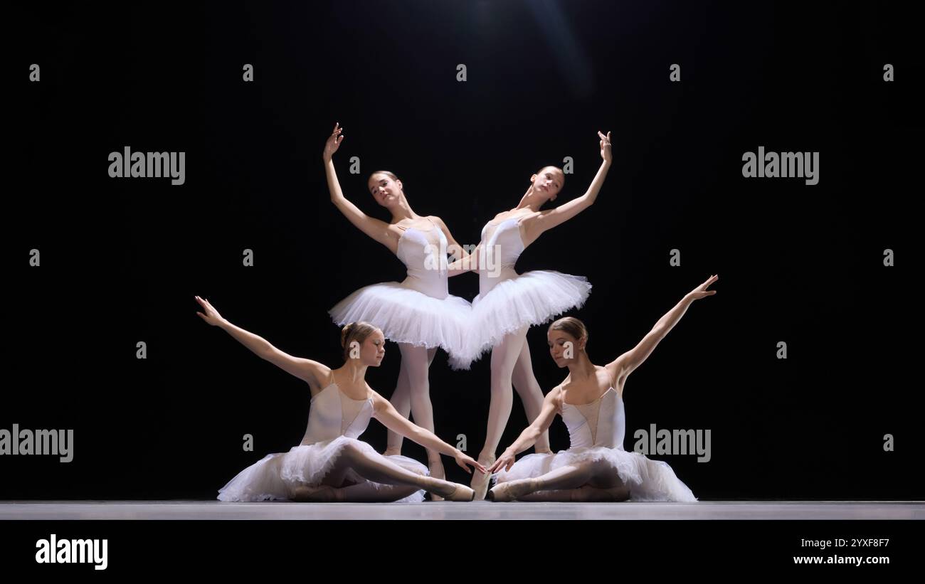 Dramatic stage formation. Group of four elegant young ballerinas ...