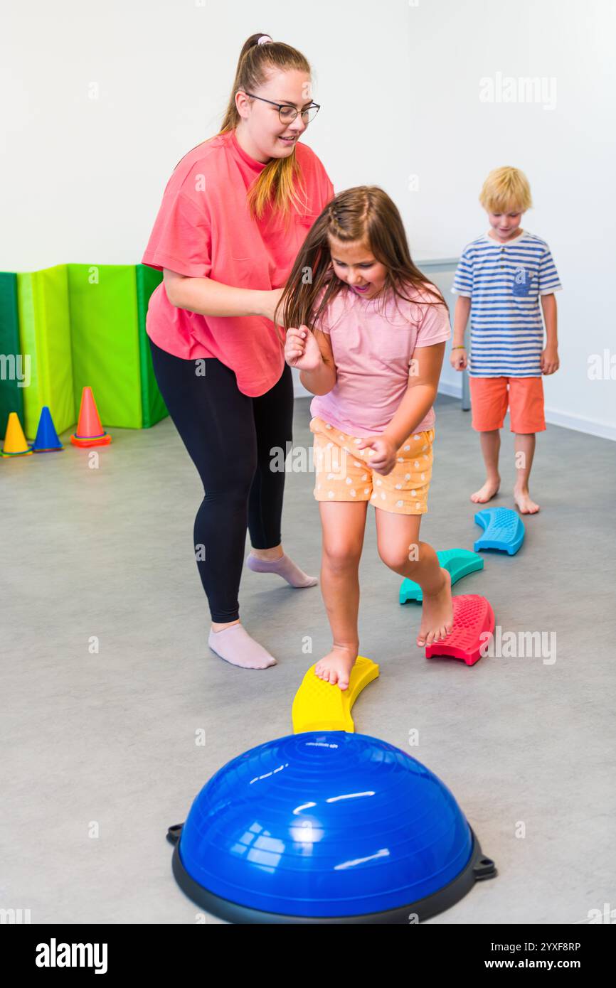 Children and female therapist during physical therapy session. Kids ...