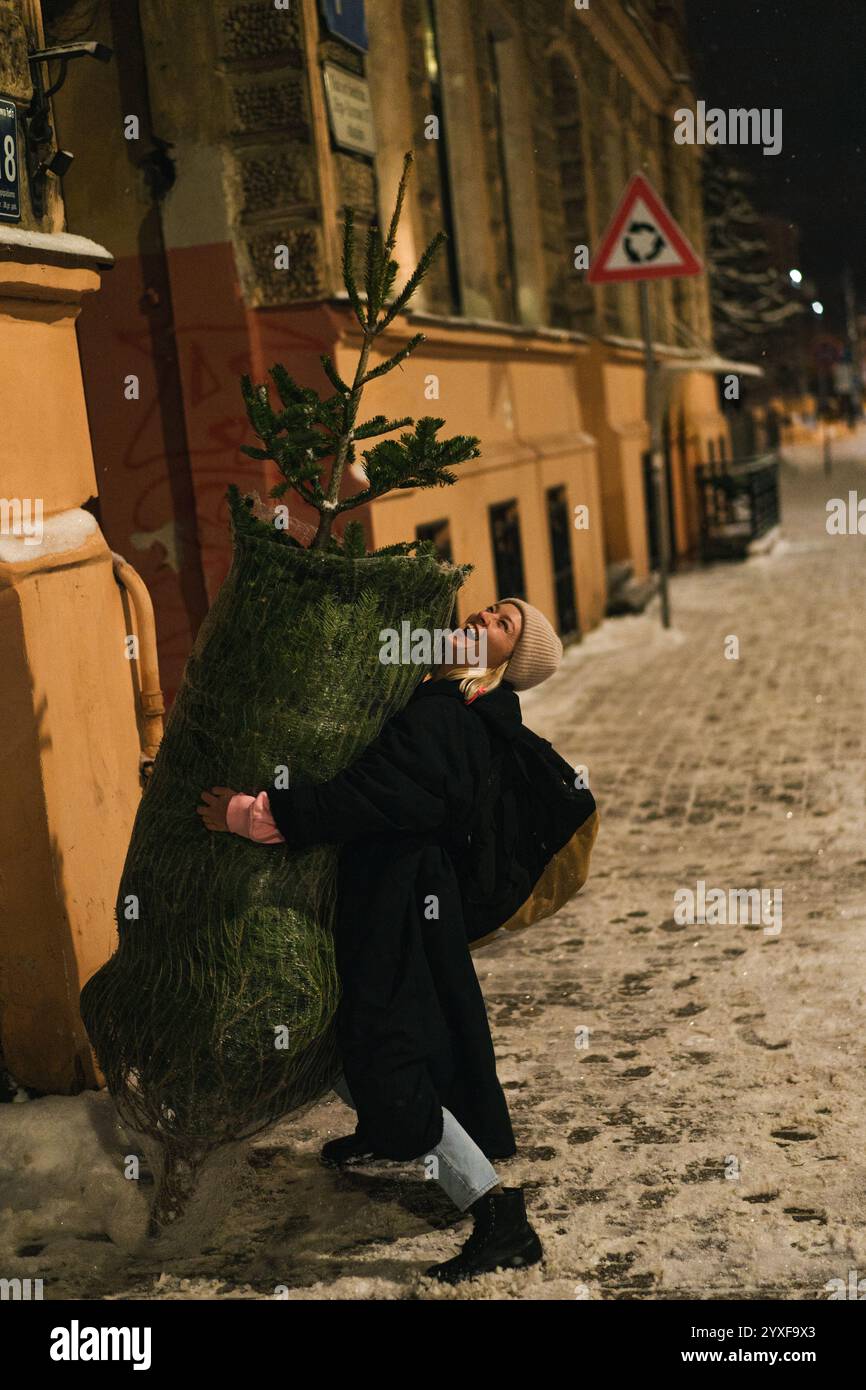 Caucasian woman walking carrying tree hi-res stock photography and ...