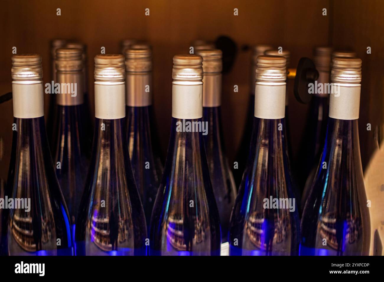 white sparkling wine in a transparent glass bottle in a display case in ...