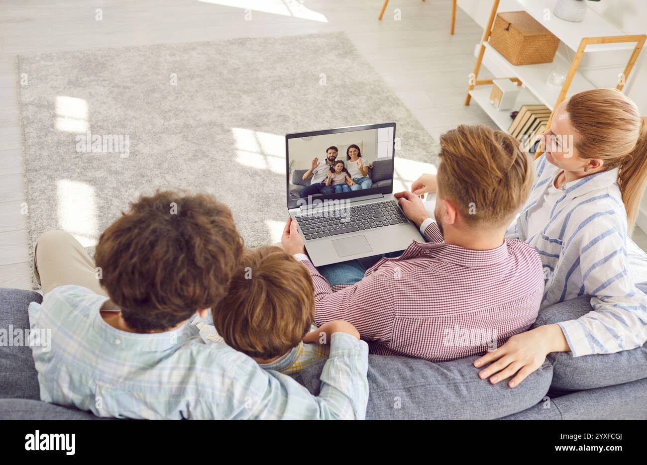 Two families call each other via video call, back view Stock Photo - Alamy