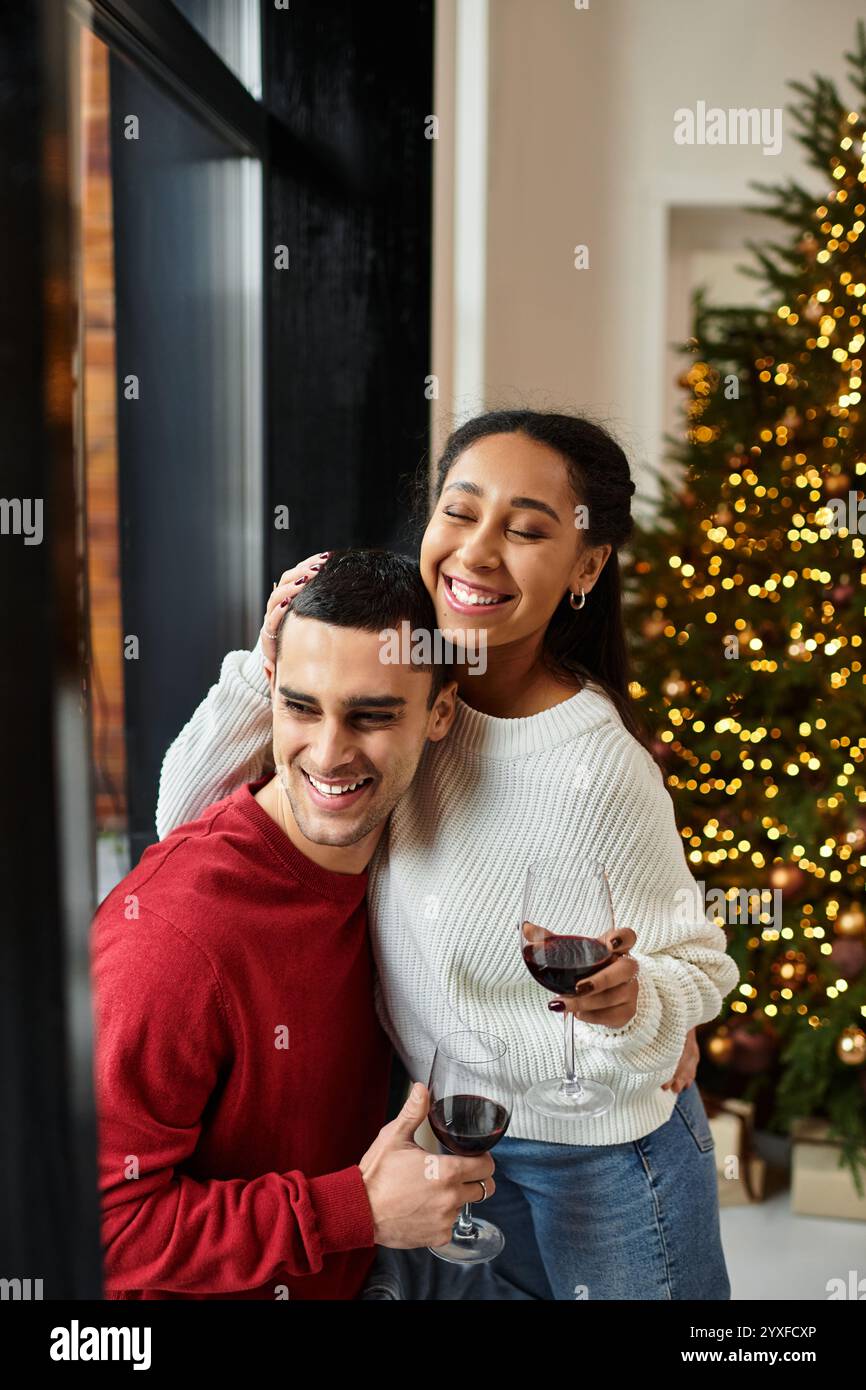 Couple enjoys a joyful moment in a stylish apartment as Christmas ...