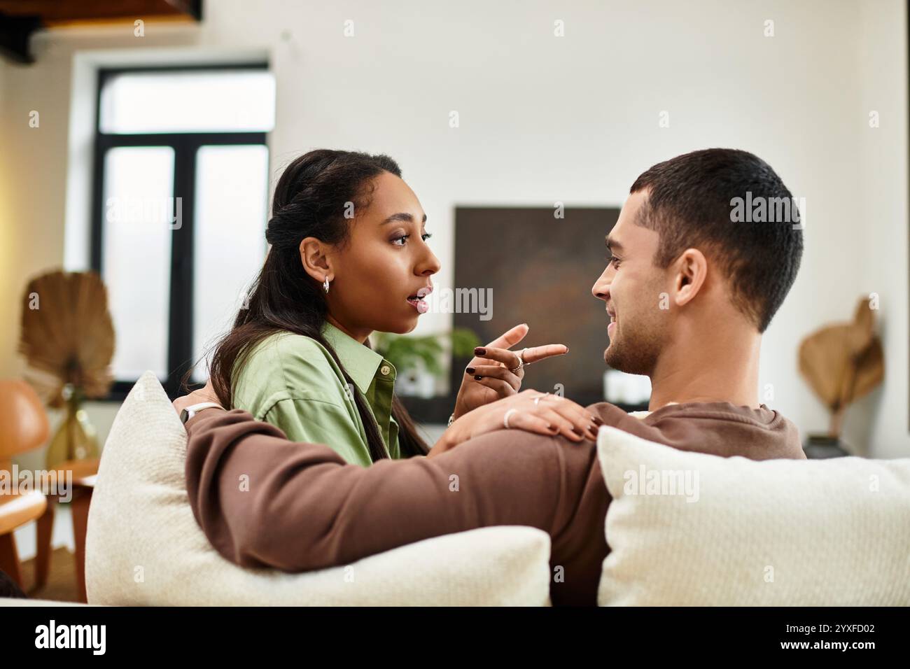 In a stylish living room, a couple shares a warm, intimate moment ...