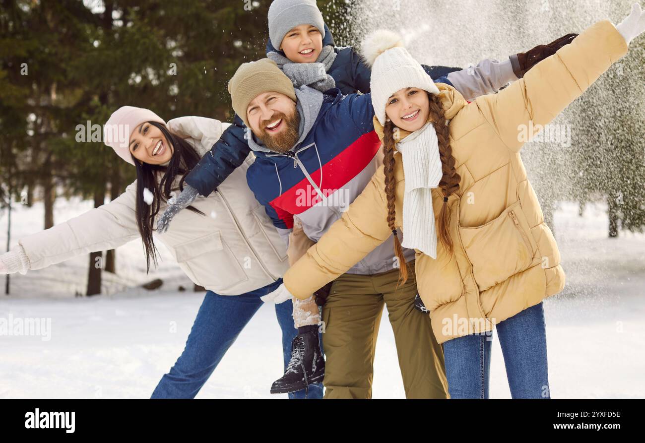 Happy winter snowy outdoor family portrait spending holiday wearing ...