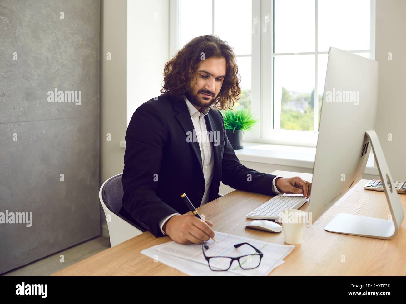 Business man working at office on a pc computer sitting at the desk on ...