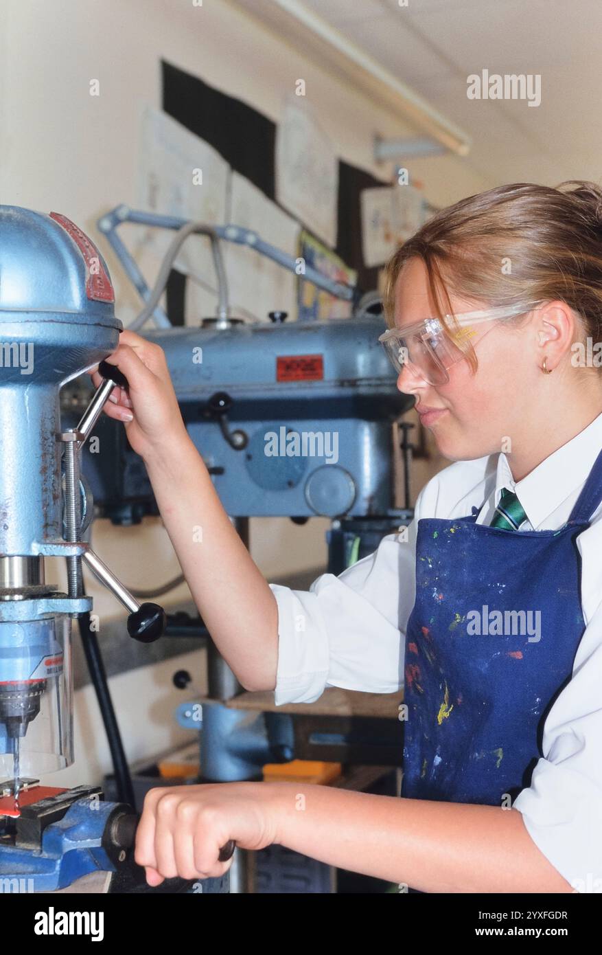 A schoolgirl working on a machine drill in a Engineering and Design ...