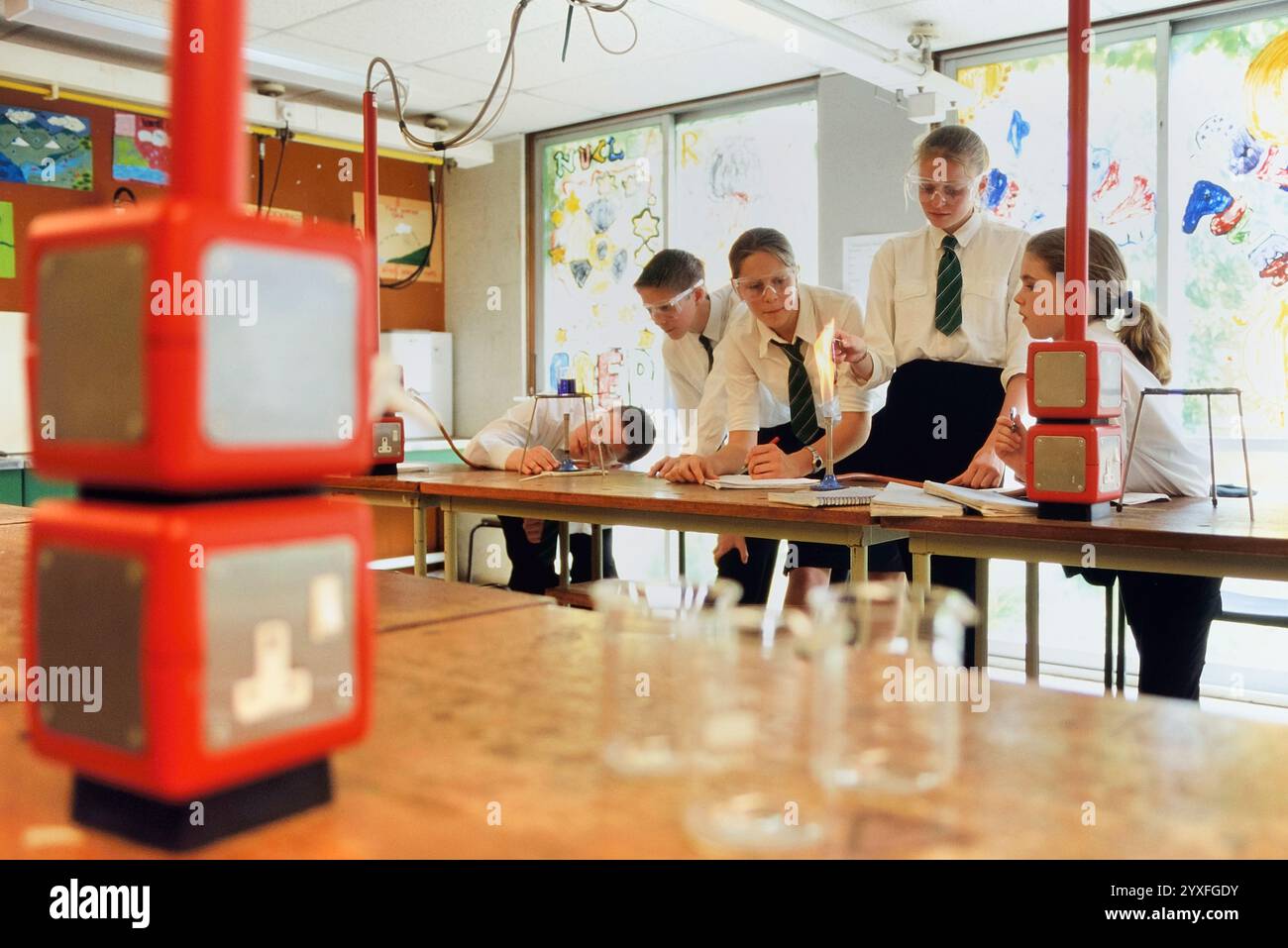 A small group of secondary school pupils working on practical ...