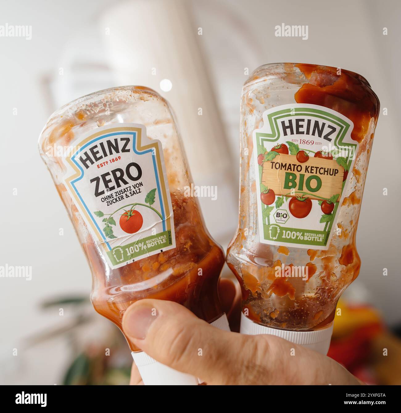 Paris, France- Sep 6, 2024: A hand holds two Heinz ketchup bottles Zero ...