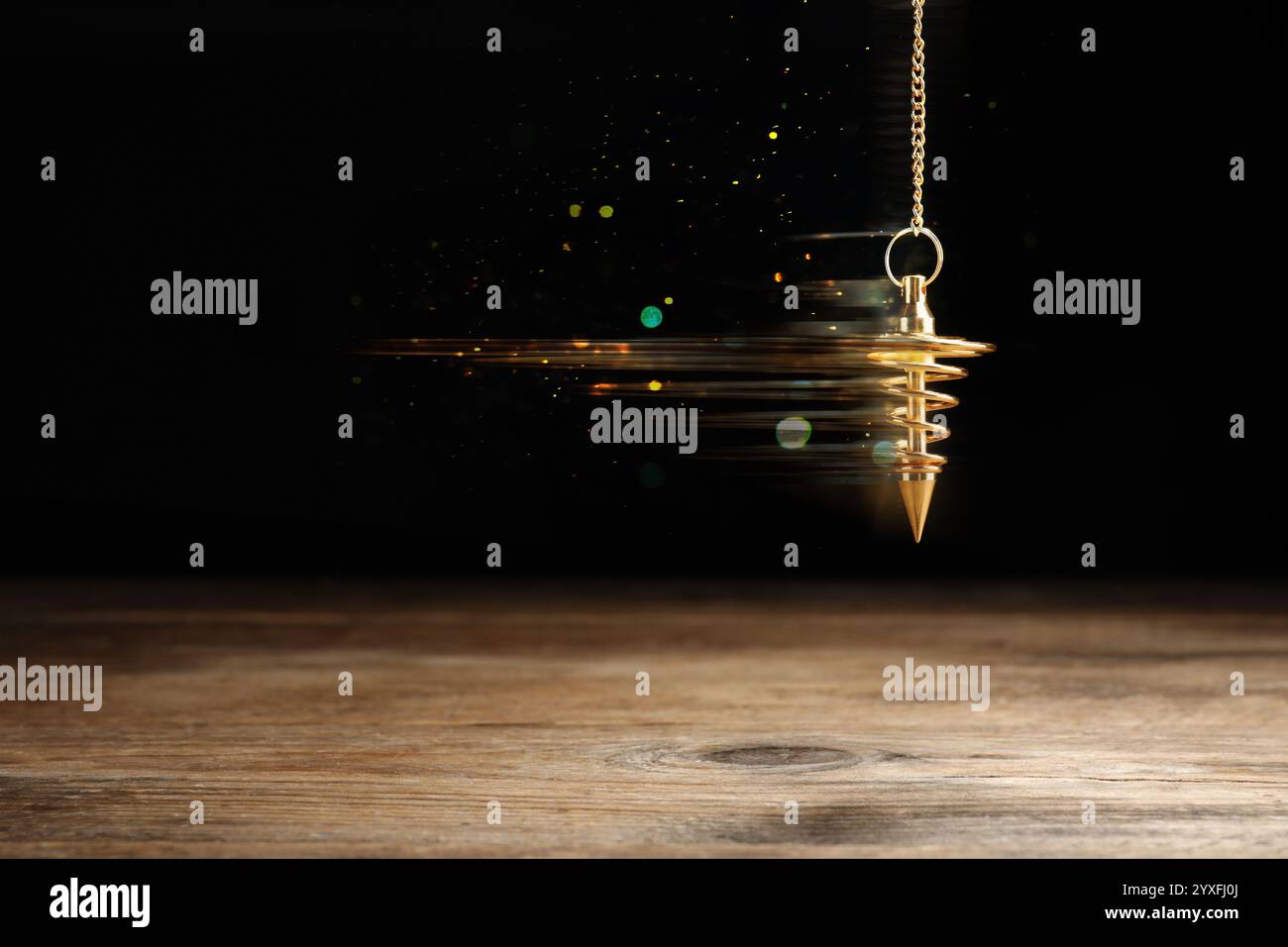 Hypnosis session. Golden pendulum swinging on black background, motion ...