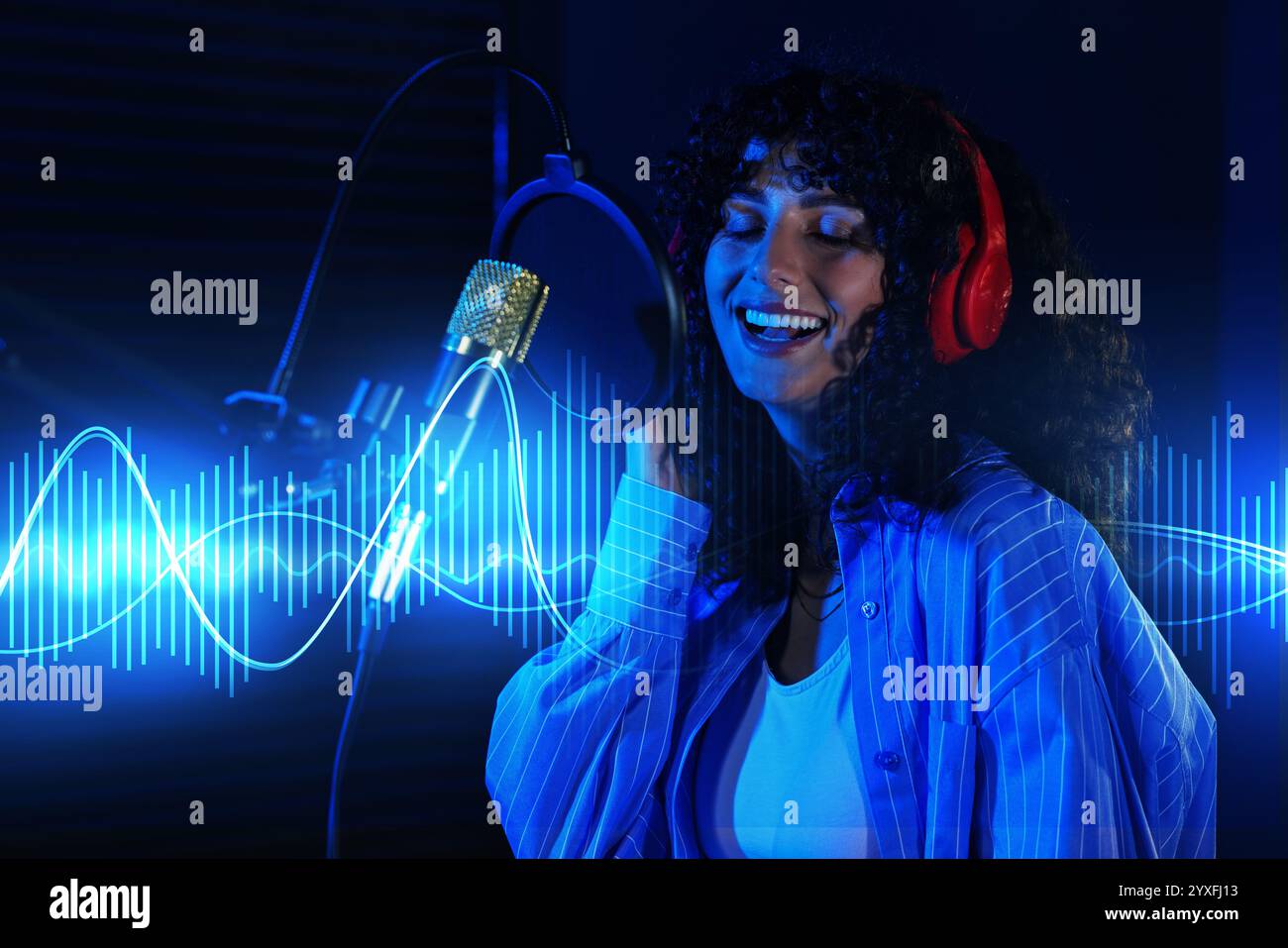 Vocalist singing into microphone in professional record studio. Sound ...