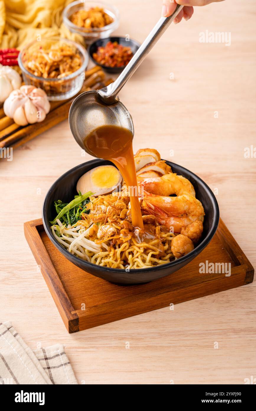 Hokkien mee or Prawn noodle are tossed in pork lard and served with ...