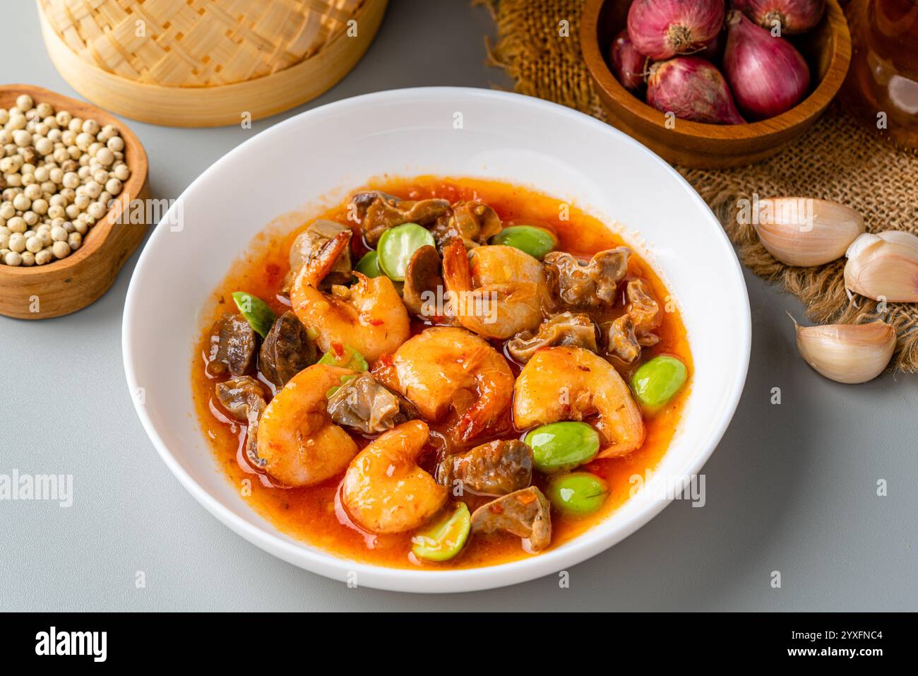Chili prawns or Sambal Udang with petai or pete served in white plate ...