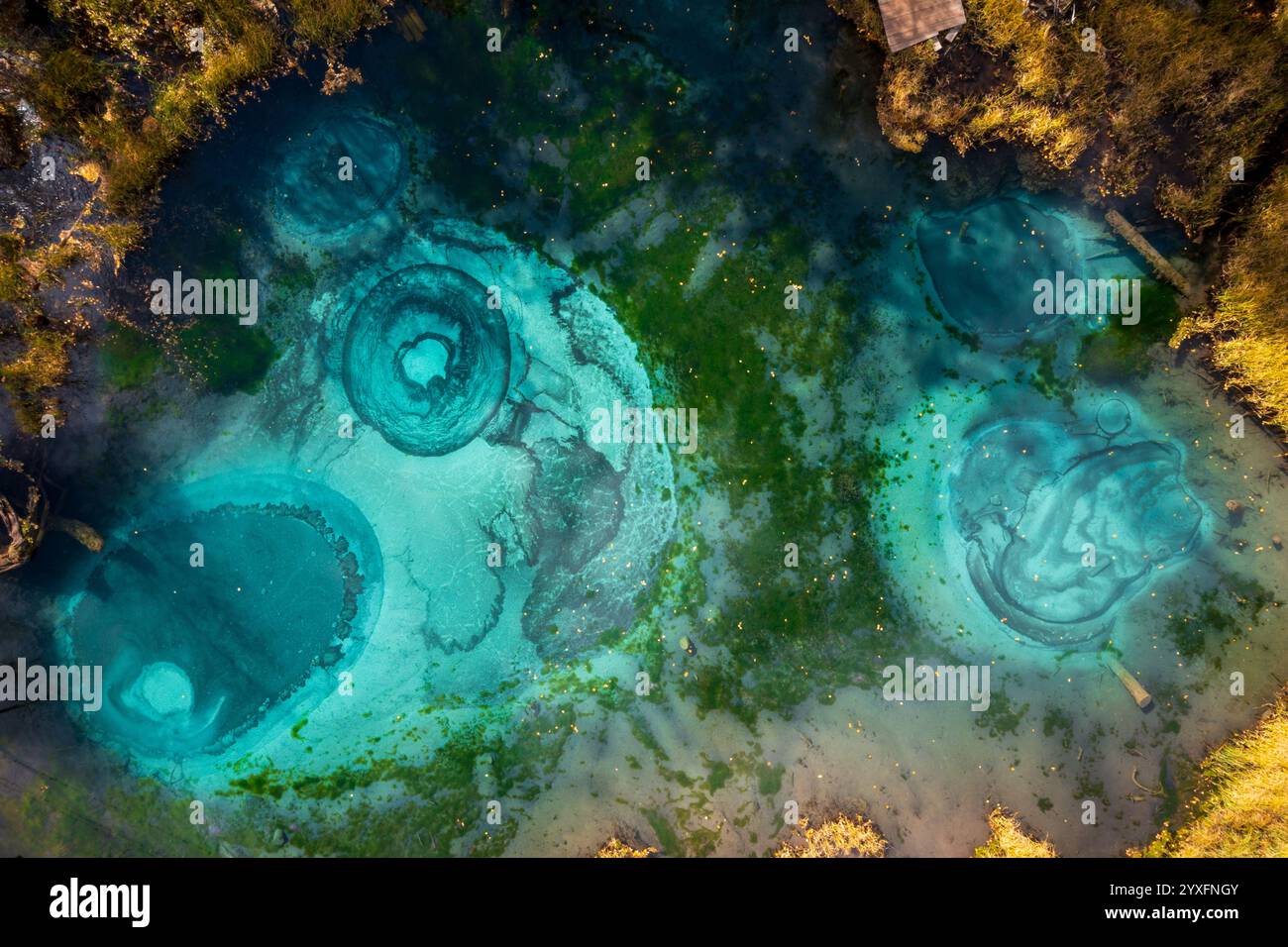Aerial image showing vivid turquoise geysers in mineral-rich water ...
