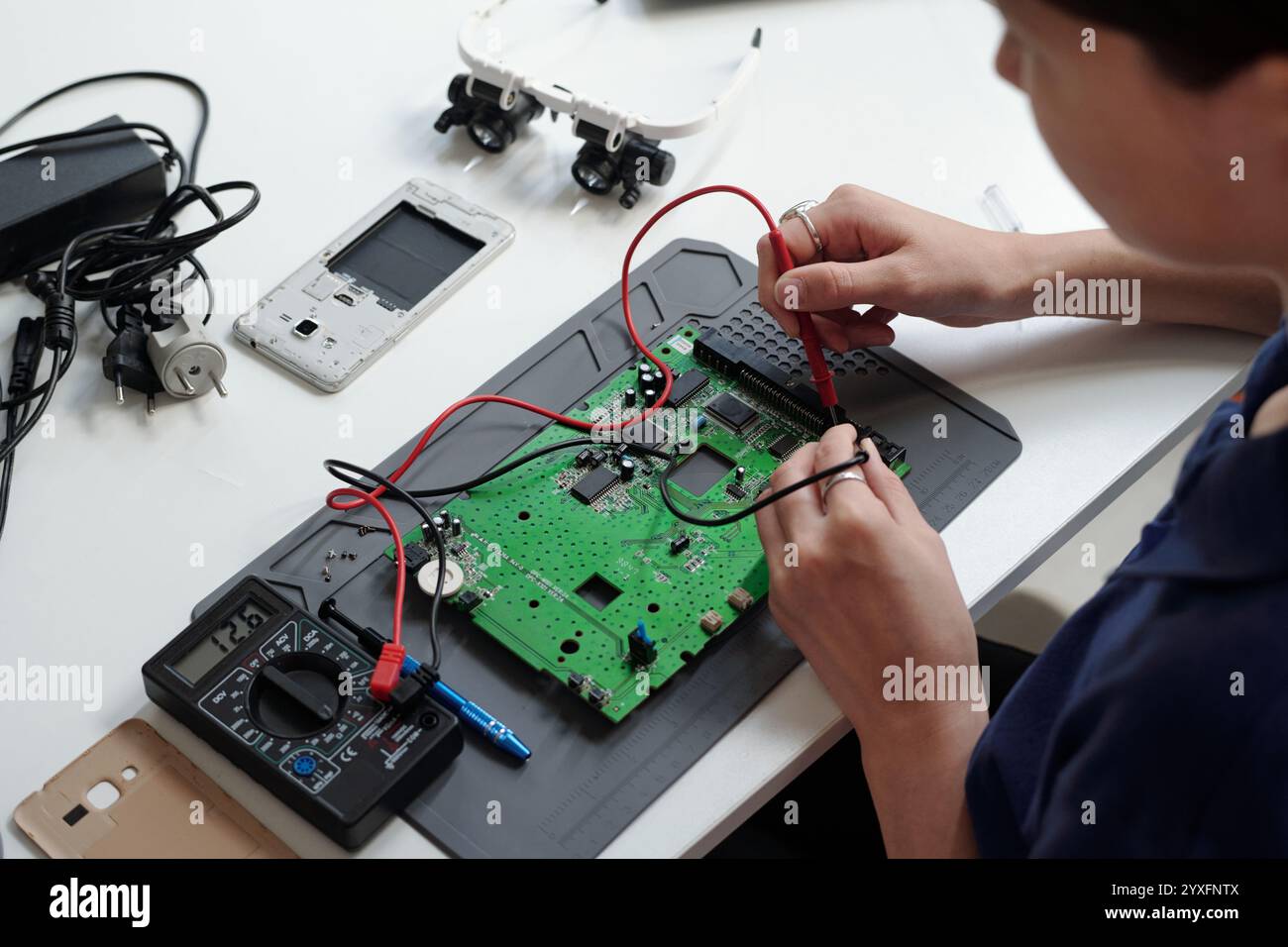 Repairing Electronic Circuit Board with Multimeter Stock Photo - Alamy