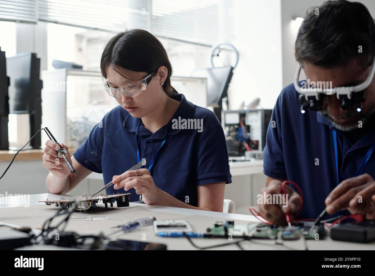 Workers Creating Technological Devices in Office Setting Stock Photo ...