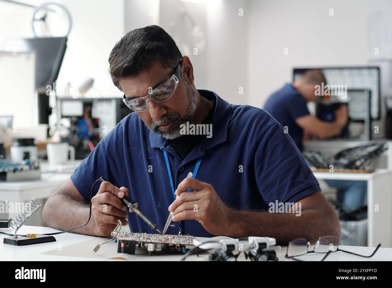 Engineer Soldering Electronic Components in Lab Stock Photo - Alamy