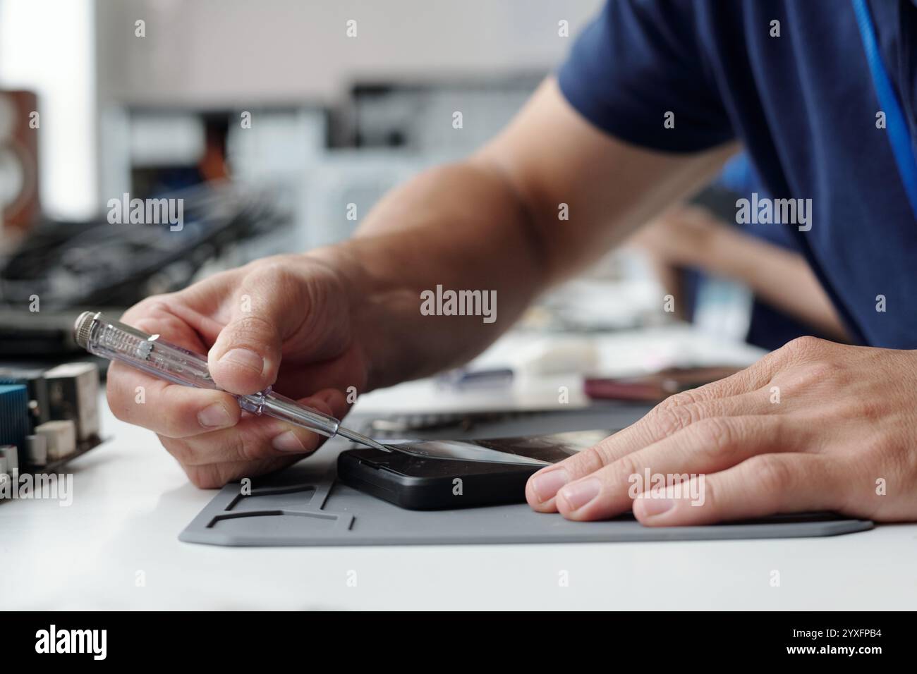 Repairing Smartphone Device with Precision Tools Stock Photo - Alamy