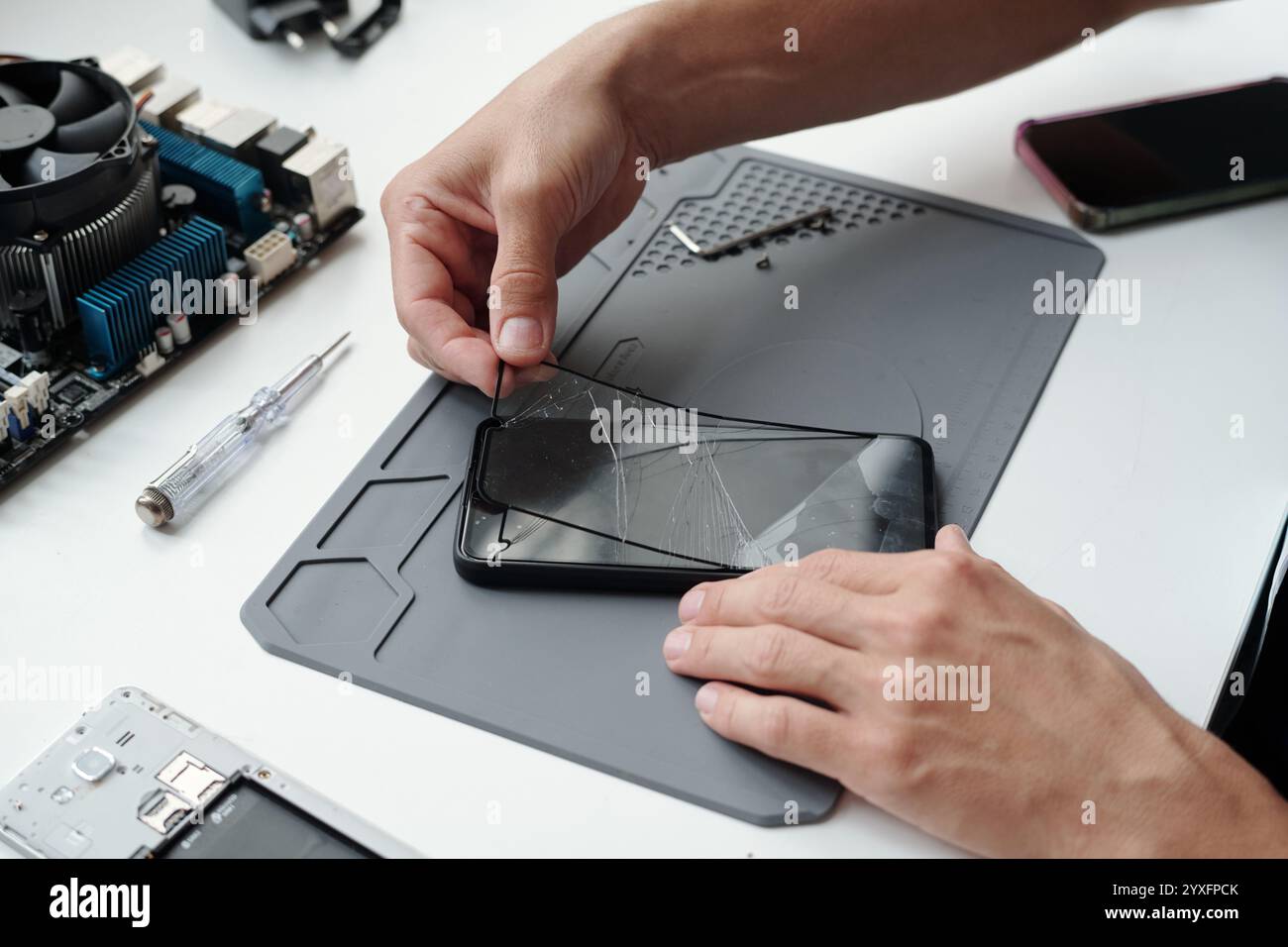 Repairing Cracked Smartphone Screen with Precision Stock Photo - Alamy