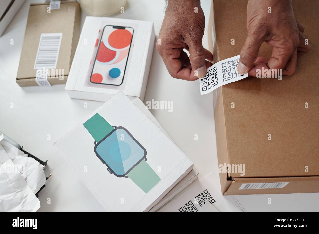 Scanning QR Code on Shipping Box in Workspace Stock Photo - Alamy