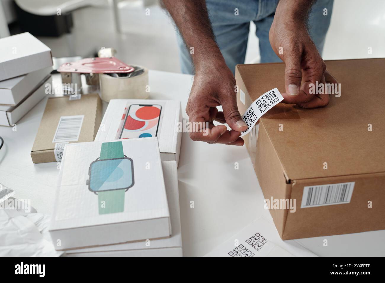 Affixing Shipping Labels on Product Packaging in Warehouse Stock Photo ...