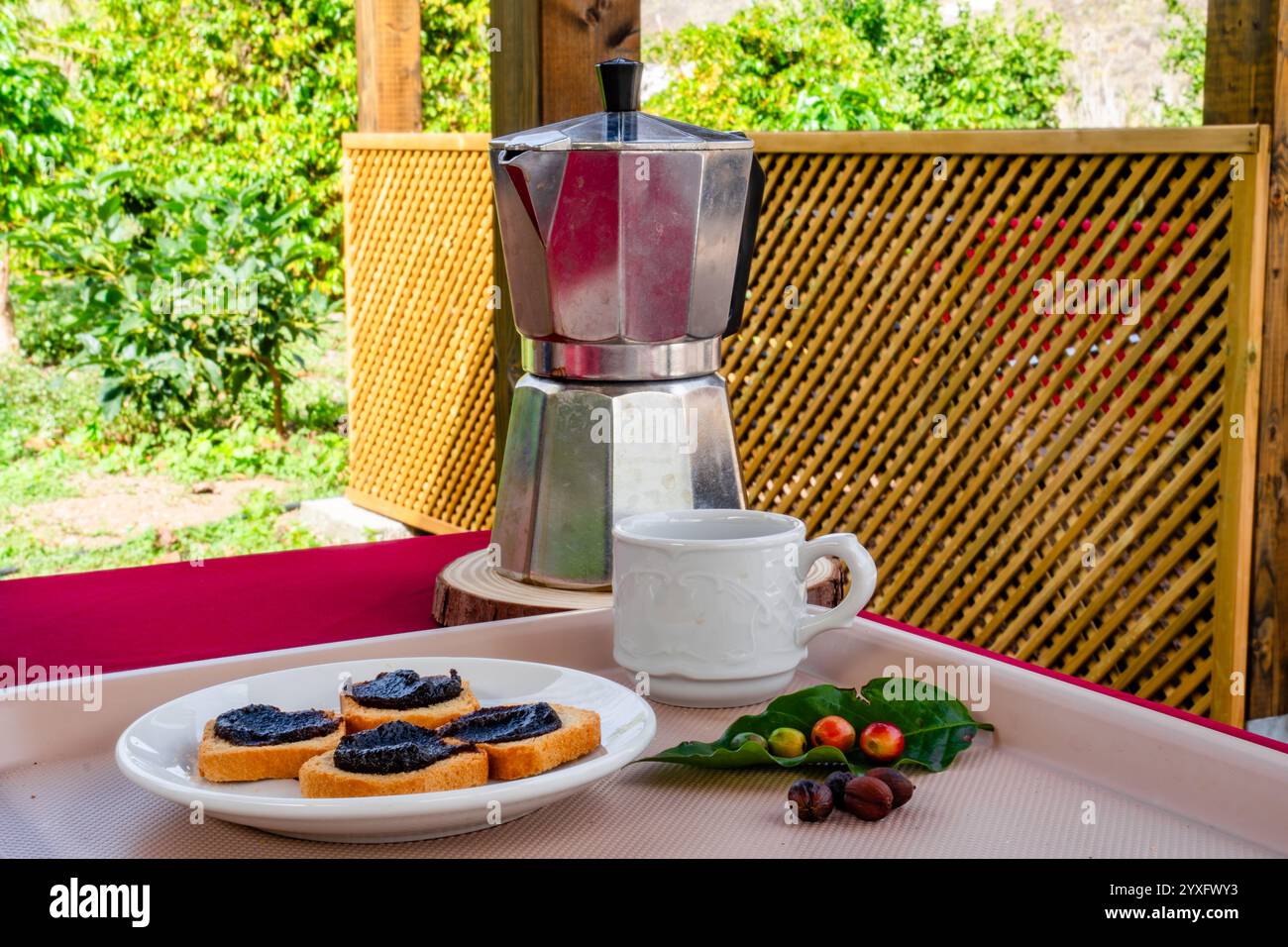 a traditional coffee maker with a coffee cup and 4 slices of bread with ...
