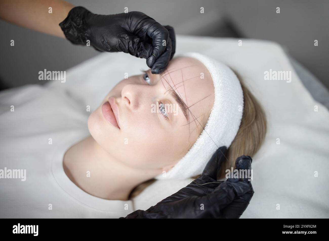 Woman experiencing permanent makeup procedure for enhanced beauty at ...