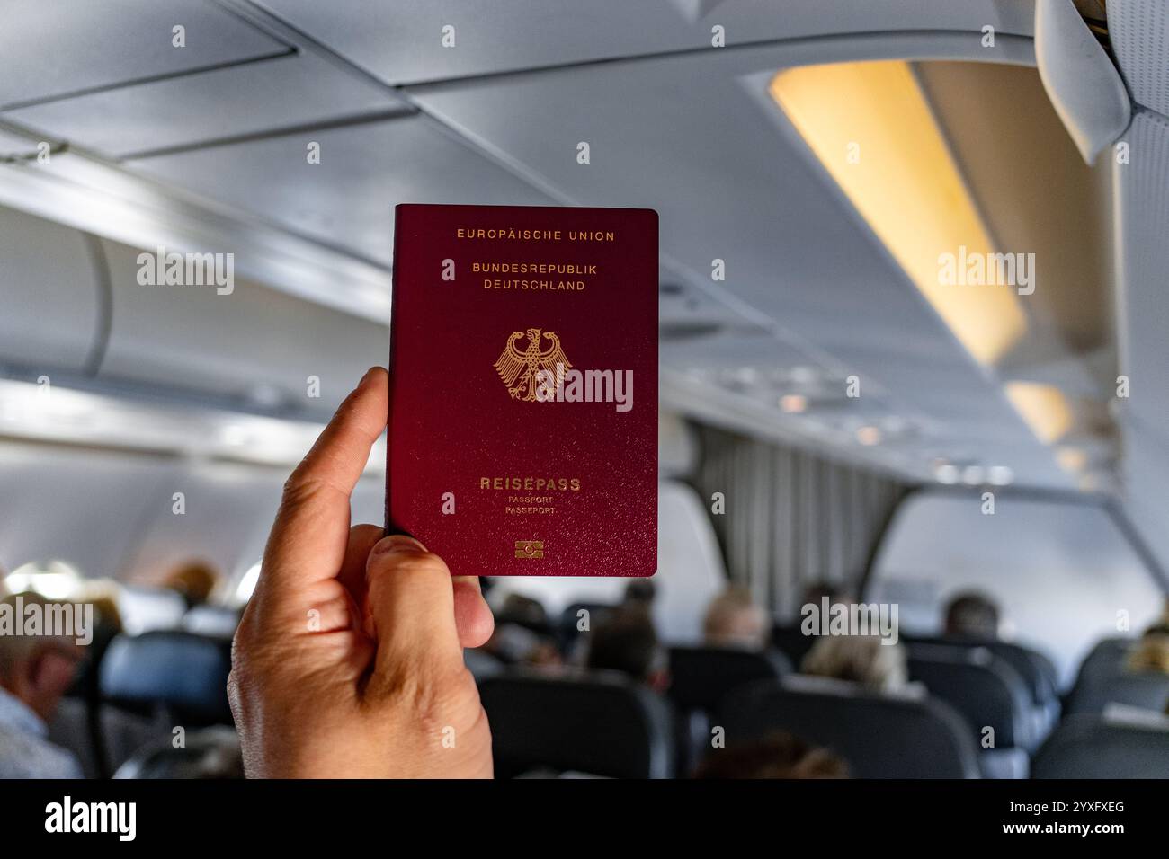 European German allemand passport holding in hand on an airplane ...