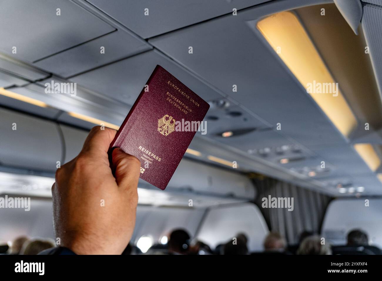European German allemand passport holding in hand on an airplane ...