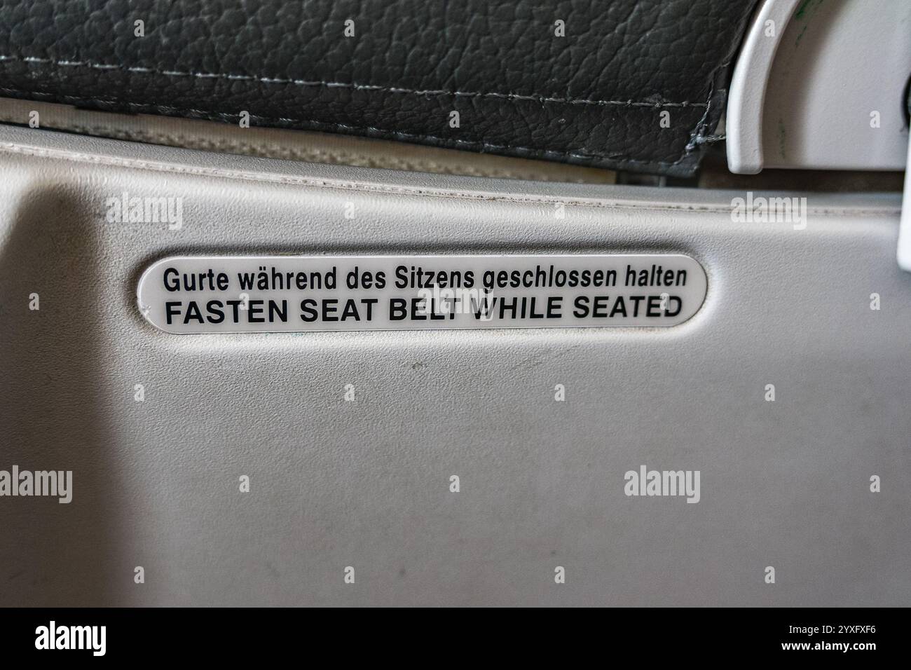 fasten seat belt while seated Stock Photo - Alamy