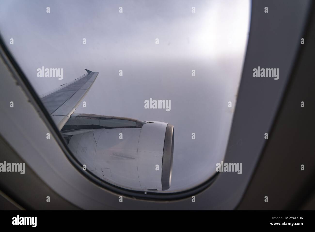 Airplane engine and wings on the sky Stock Photo - Alamy