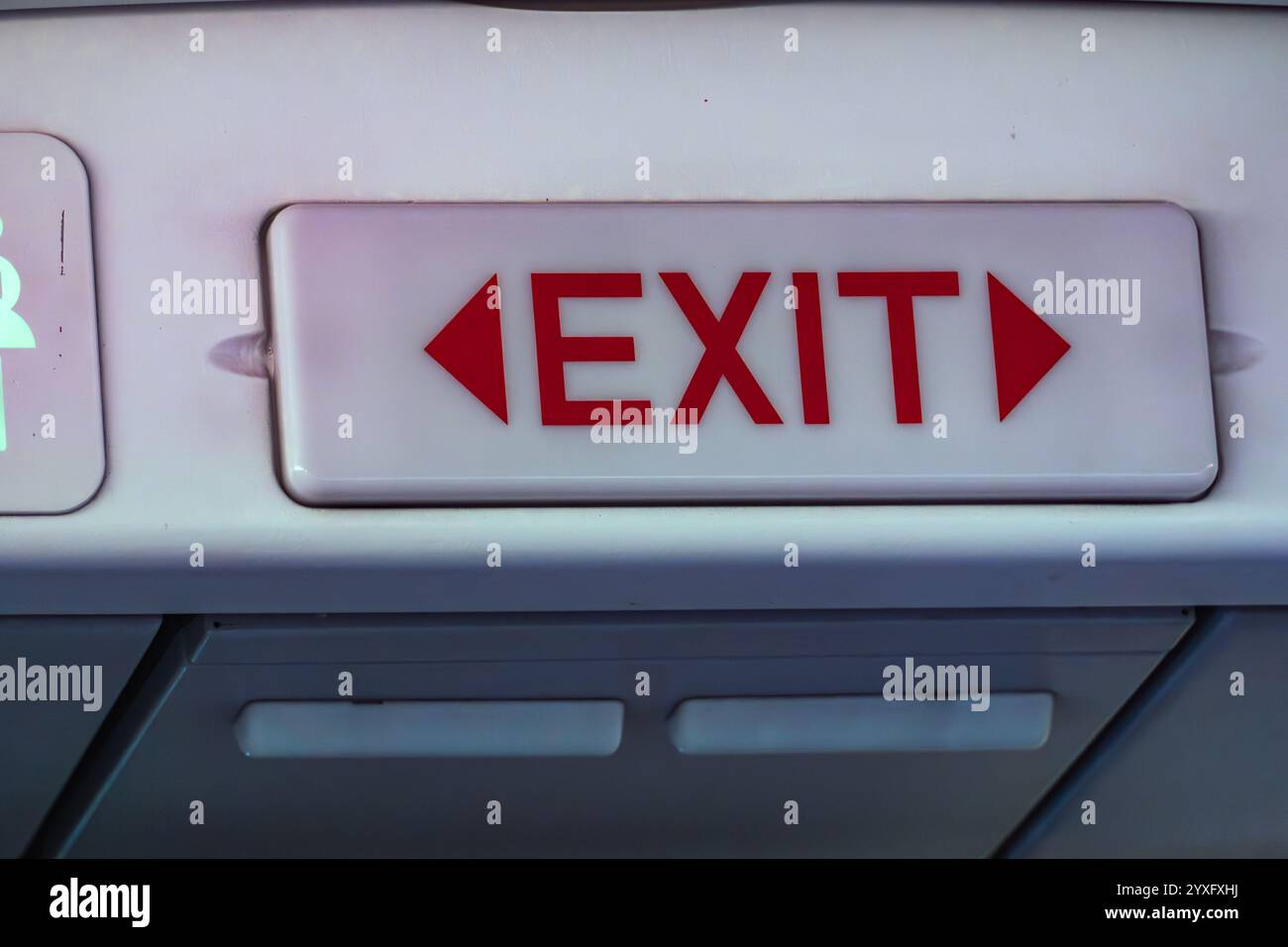 Exit sign on an airplane Stock Photo - Alamy