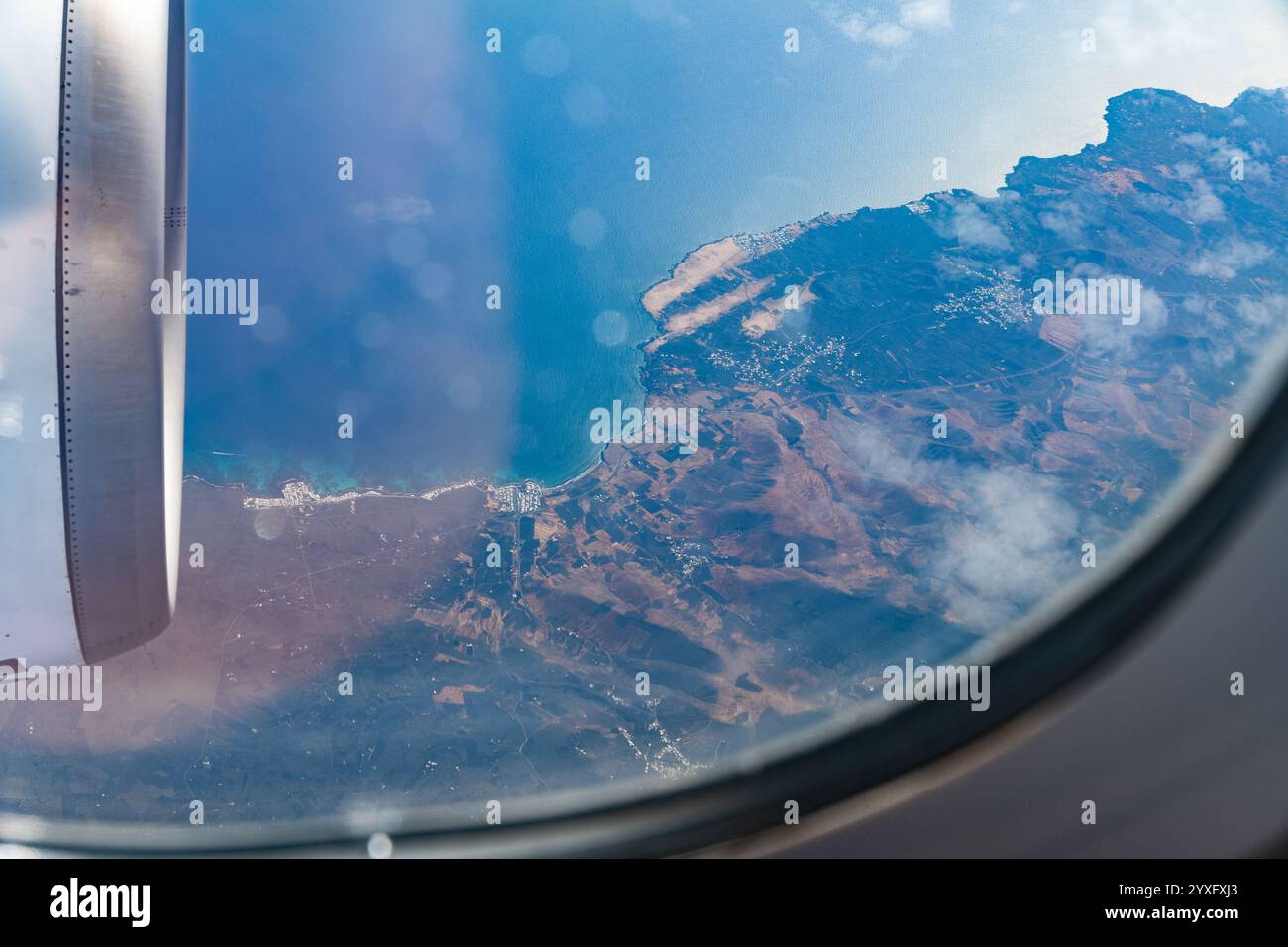 A commercial airplane flying high in the sky looking through a window ...