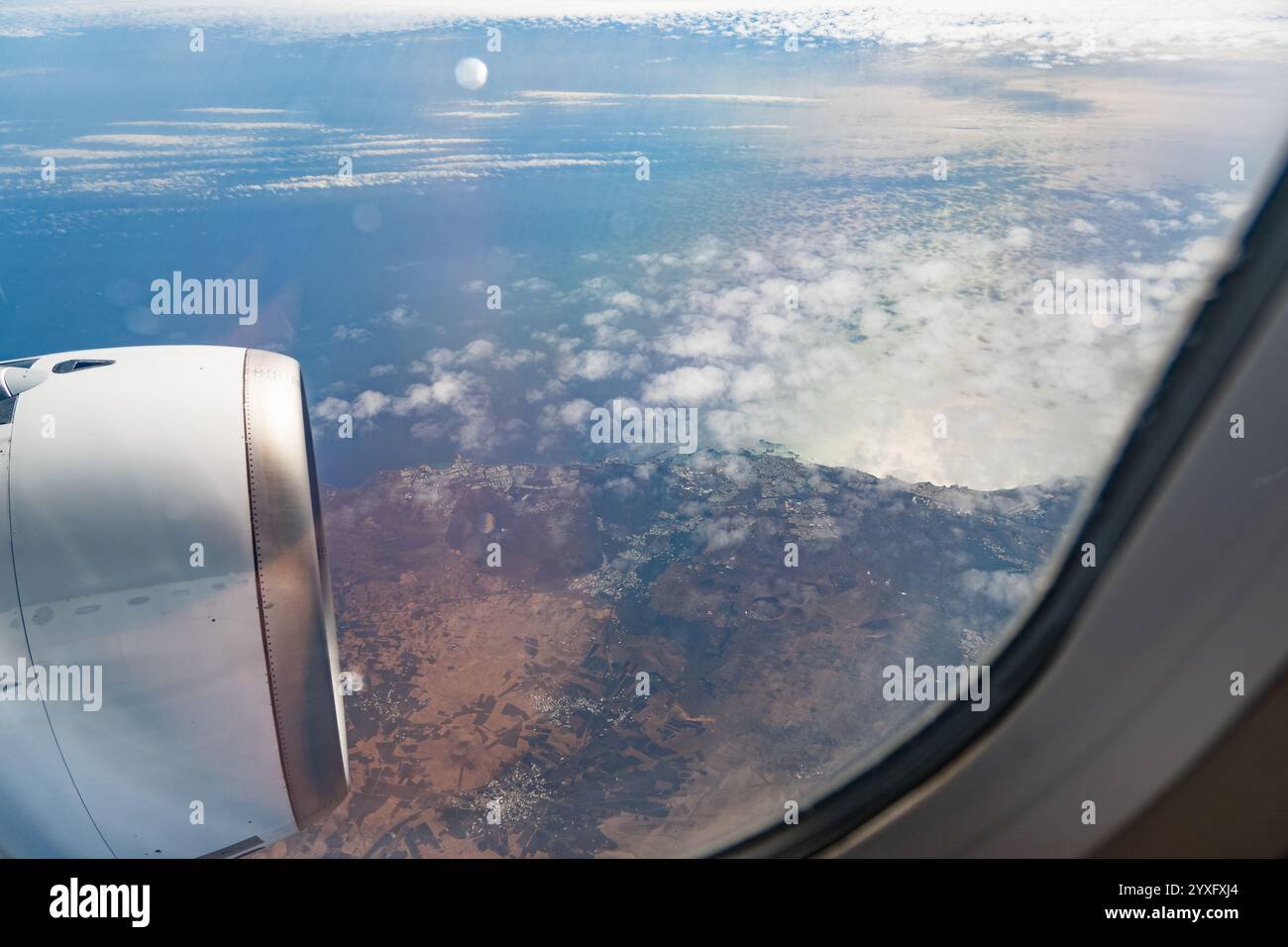 A commercial airplane flying high in the sky looking through a window ...