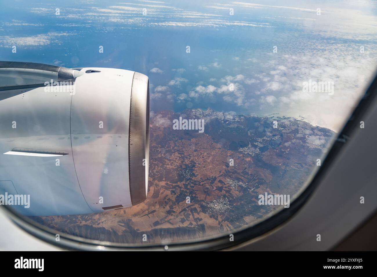 A commercial airplane flying high in the sky looking through a window ...
