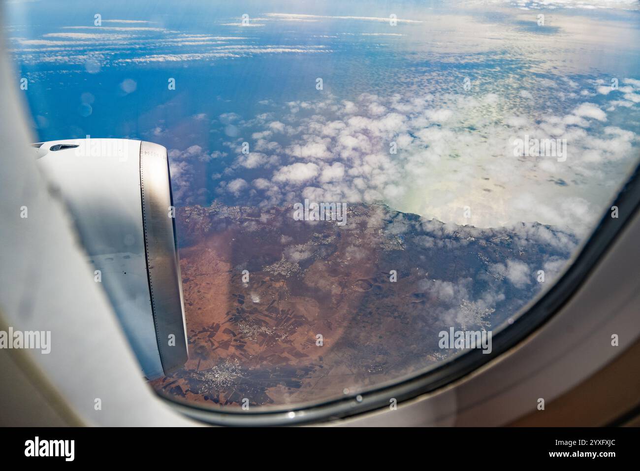 A commercial airplane flying high in the sky looking through a window ...