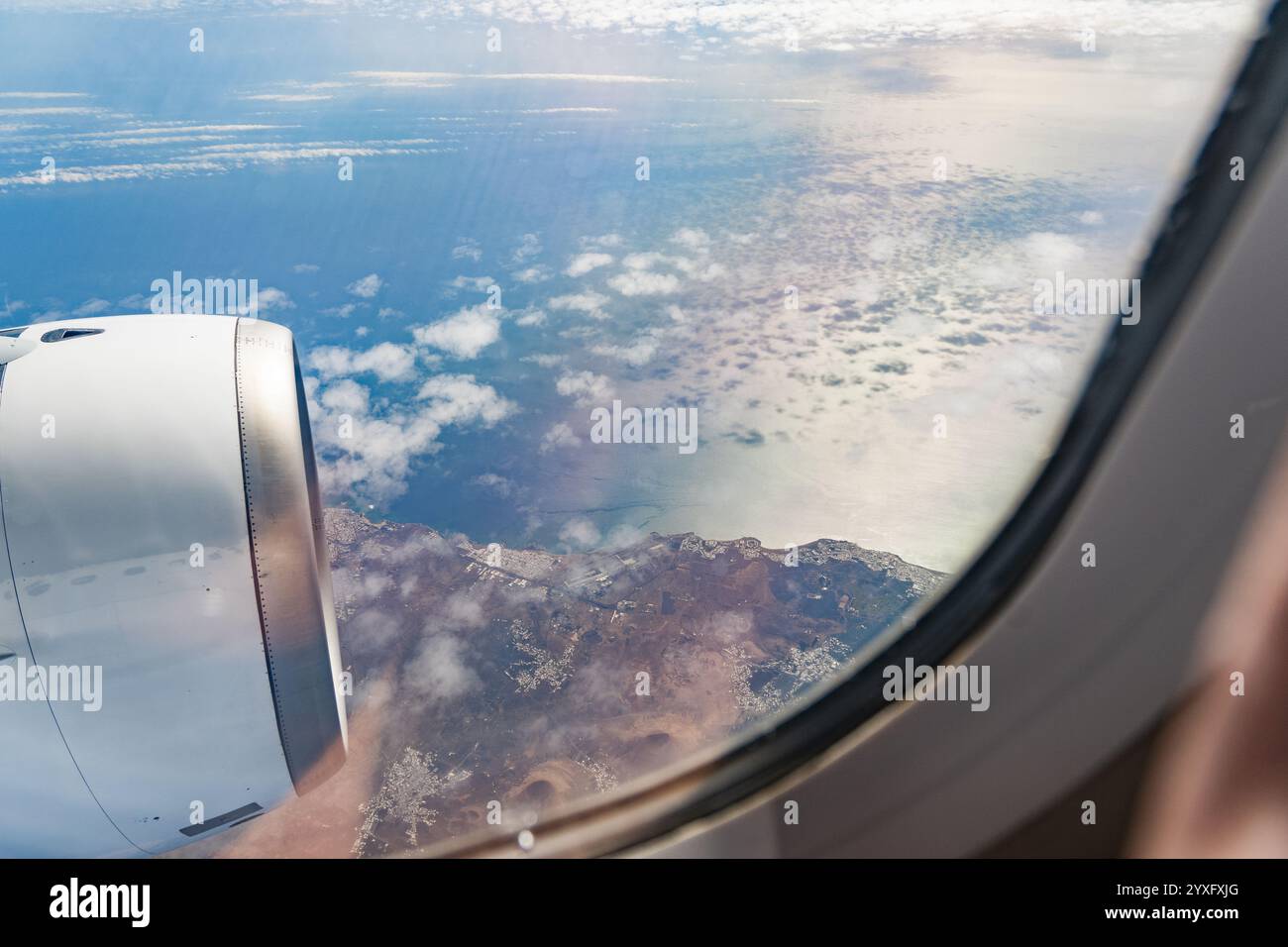 A commercial airplane flying high in the sky looking through a window ...