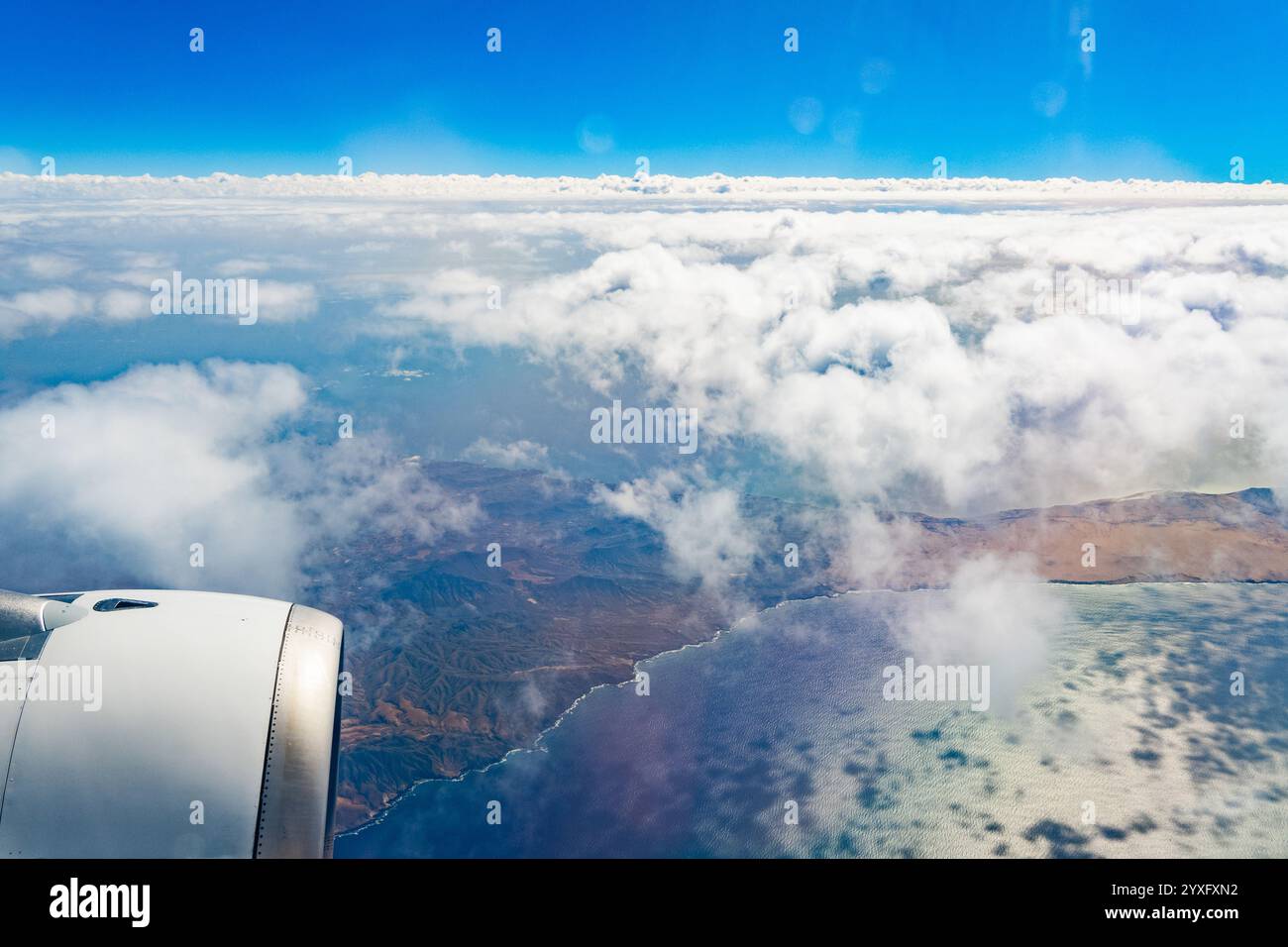 A commercial airplane flying high in the sky looking through a window ...