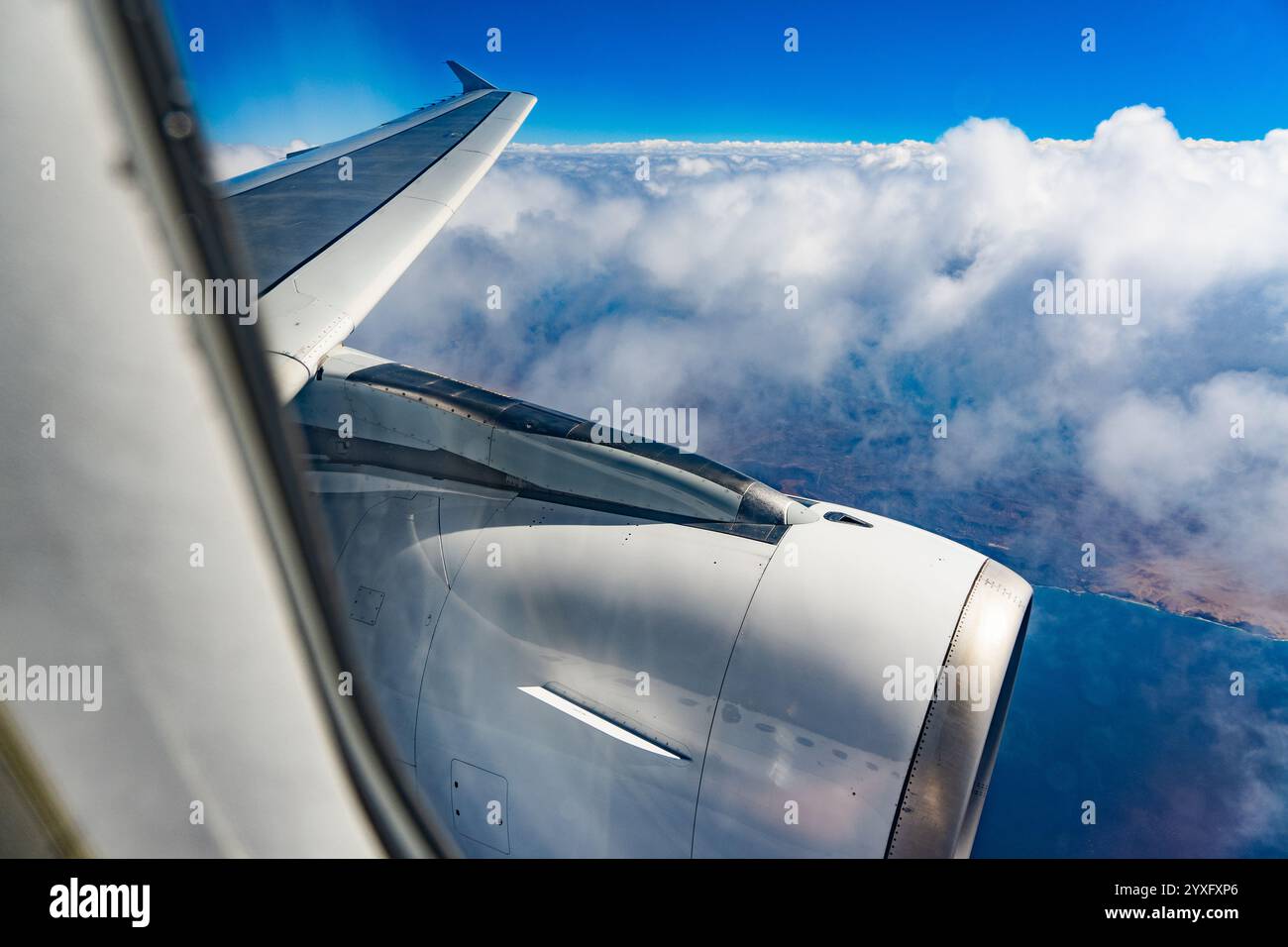 A commercial airplane flying high in the sky looking through a window ...
