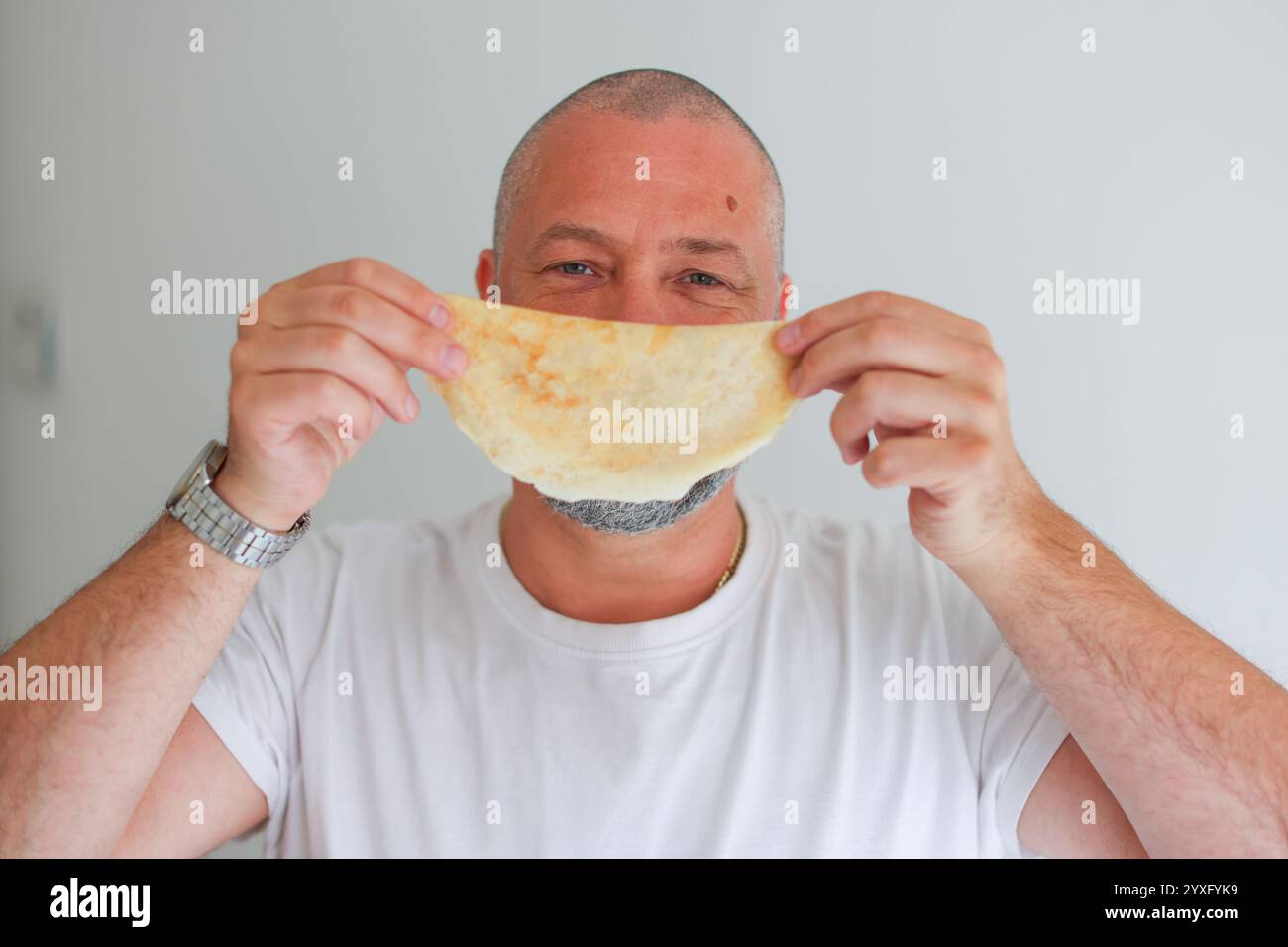 man make smile from pancakes. Positive man eating healthy homemade food ...