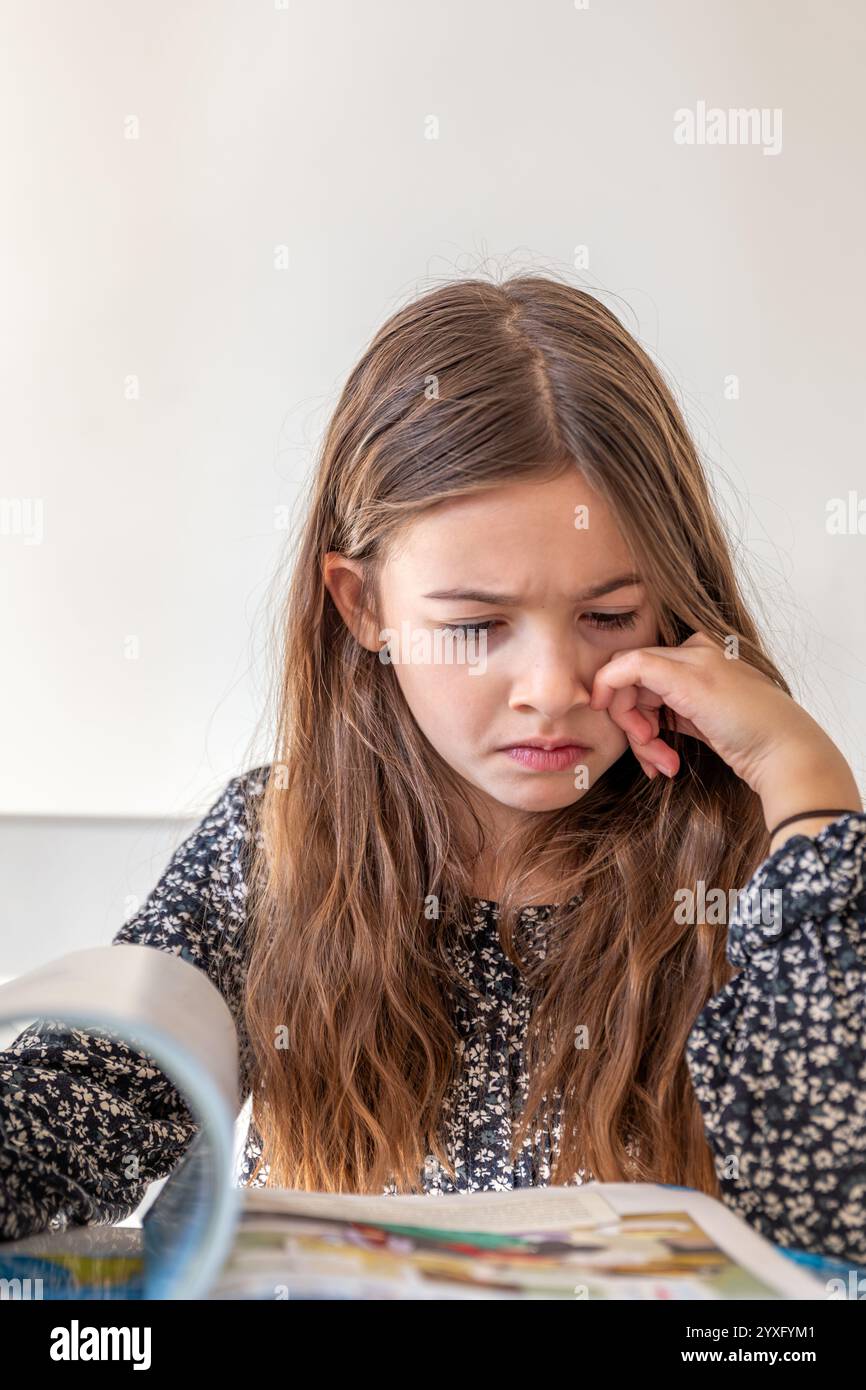 Sad child reading book hi-res stock photography and images - Alamy