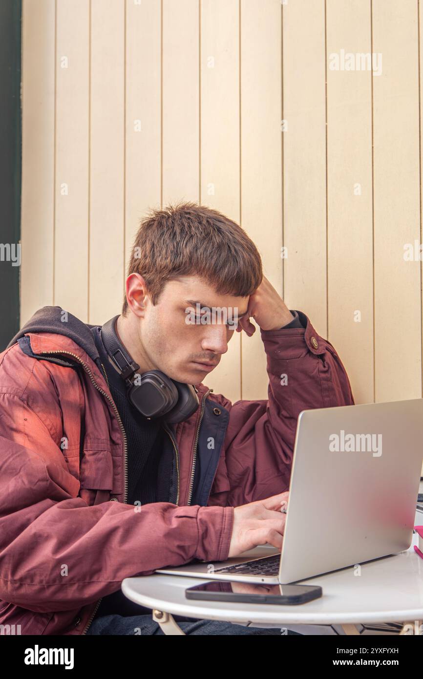 A student studies using a laptop. Male student studying online Stock ...