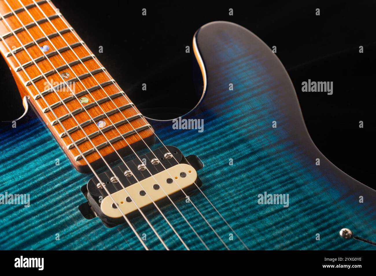 Detail of the neck, the pickup and the strings of a blue electric ...